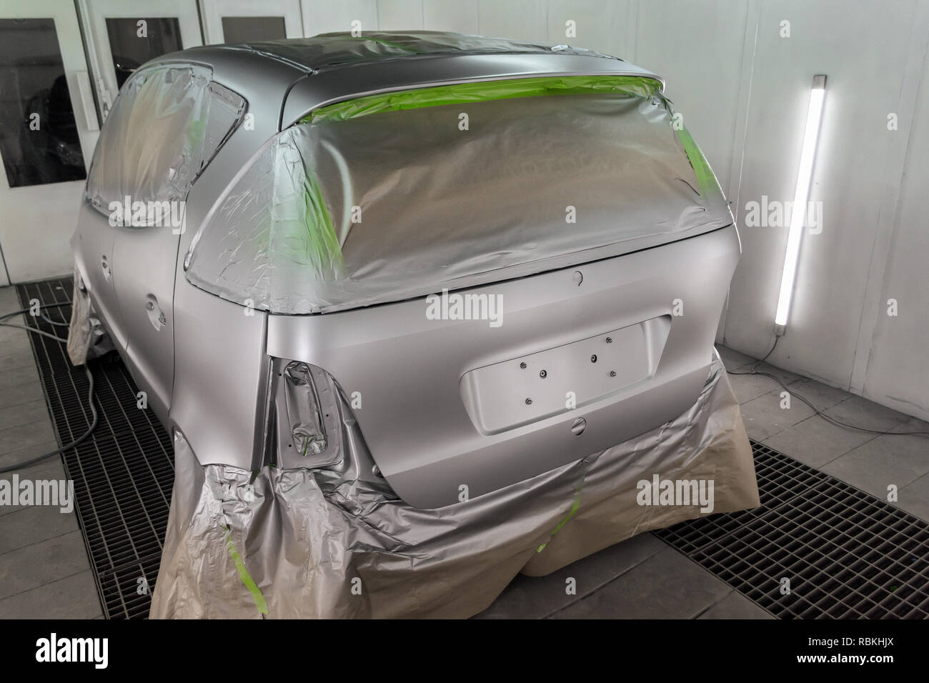 Full painting of the car in the back of a silver hatchback window and ...