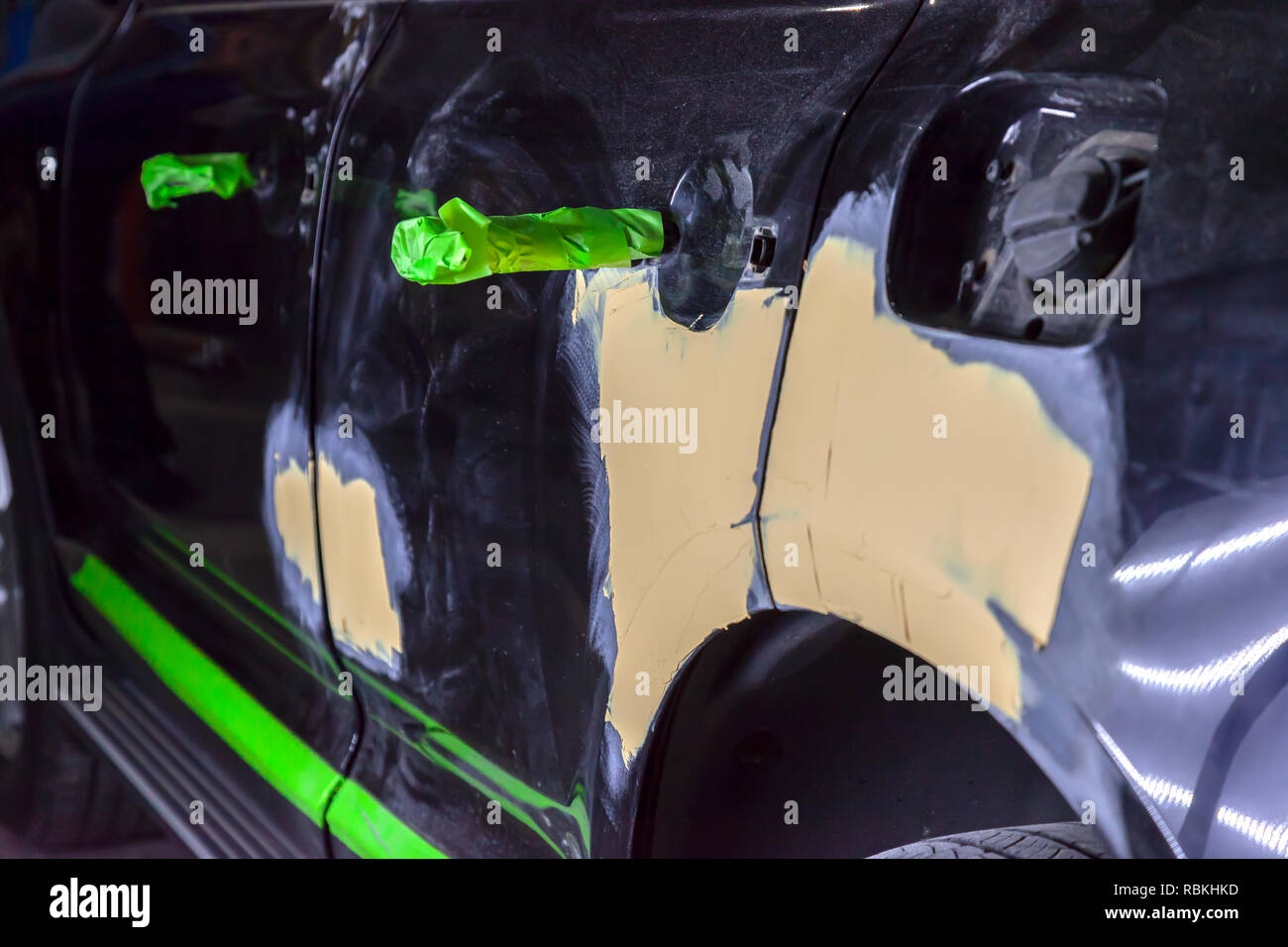 Repair of car body parts in black after an accident and scratches by ...