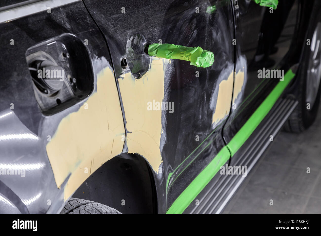 Repair of car body parts in black after an accident and scratches by ...