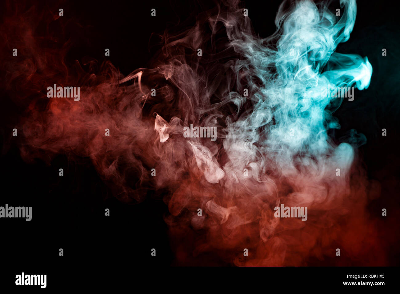 A background of blue, red and green wavy smoke in the shape of a ghost ...