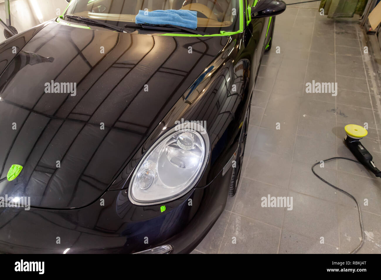 Cleaning and maintenance of a black car at the station after washing ...