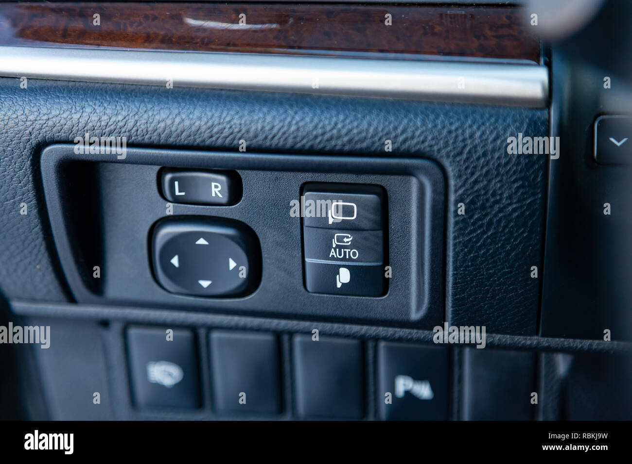 The buttons for controlling the mirrors electric drive on the center ...