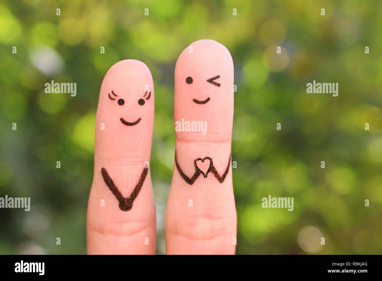 Fingers art of happy couple. Boyfriend showing fingers in heart shape ...