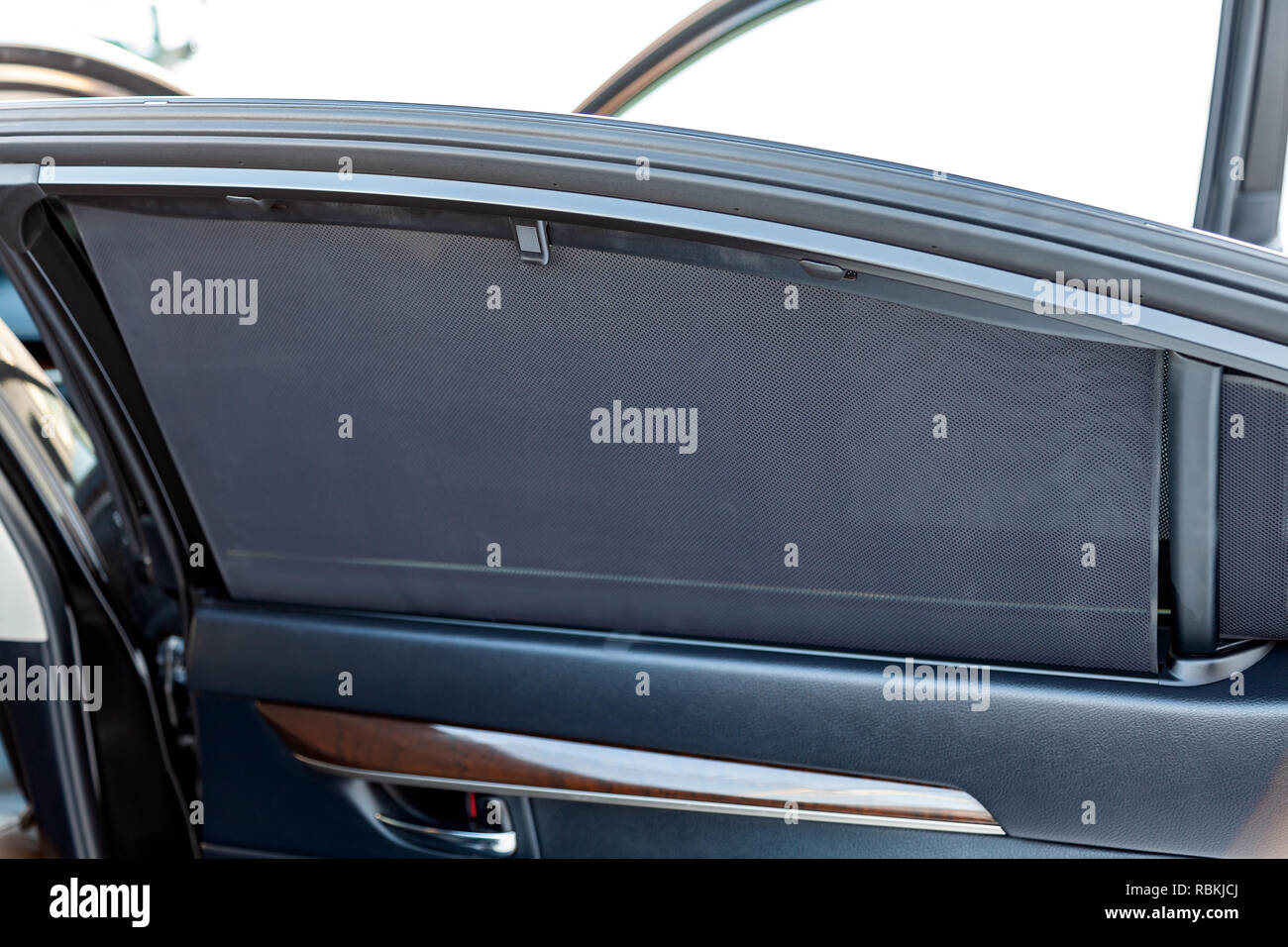 Sunblind on the glass of the rear door of the car black color close-up ...