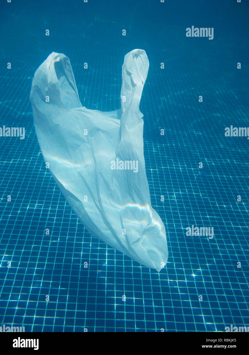 Plastic bag floating into the water. Polluted environmental. Recycle ...