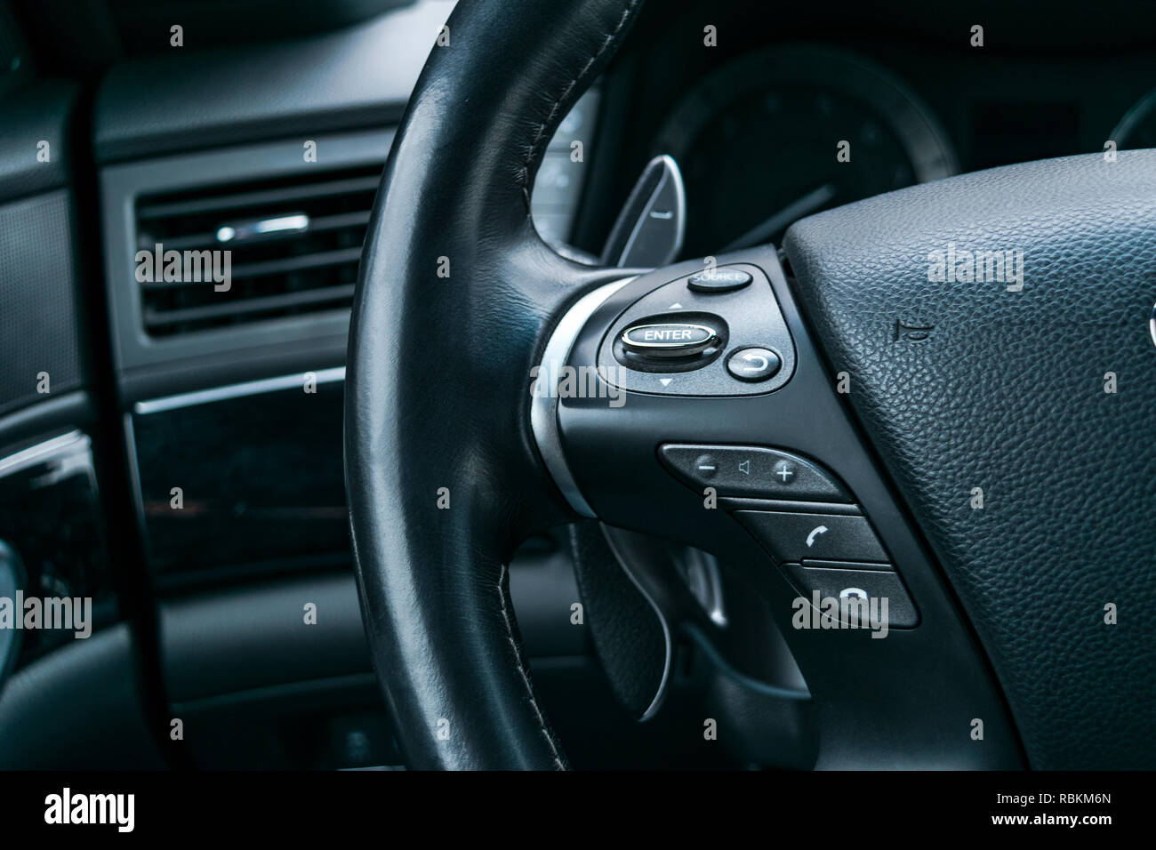 Media control buttons on the steering wheel in black perforated leather ...