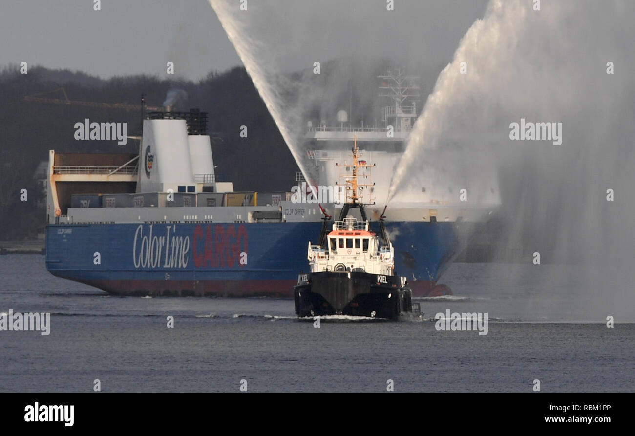 Kiel, Germany. 11th Jan, 2019. Accompanied by a water-spraying tug, the ...