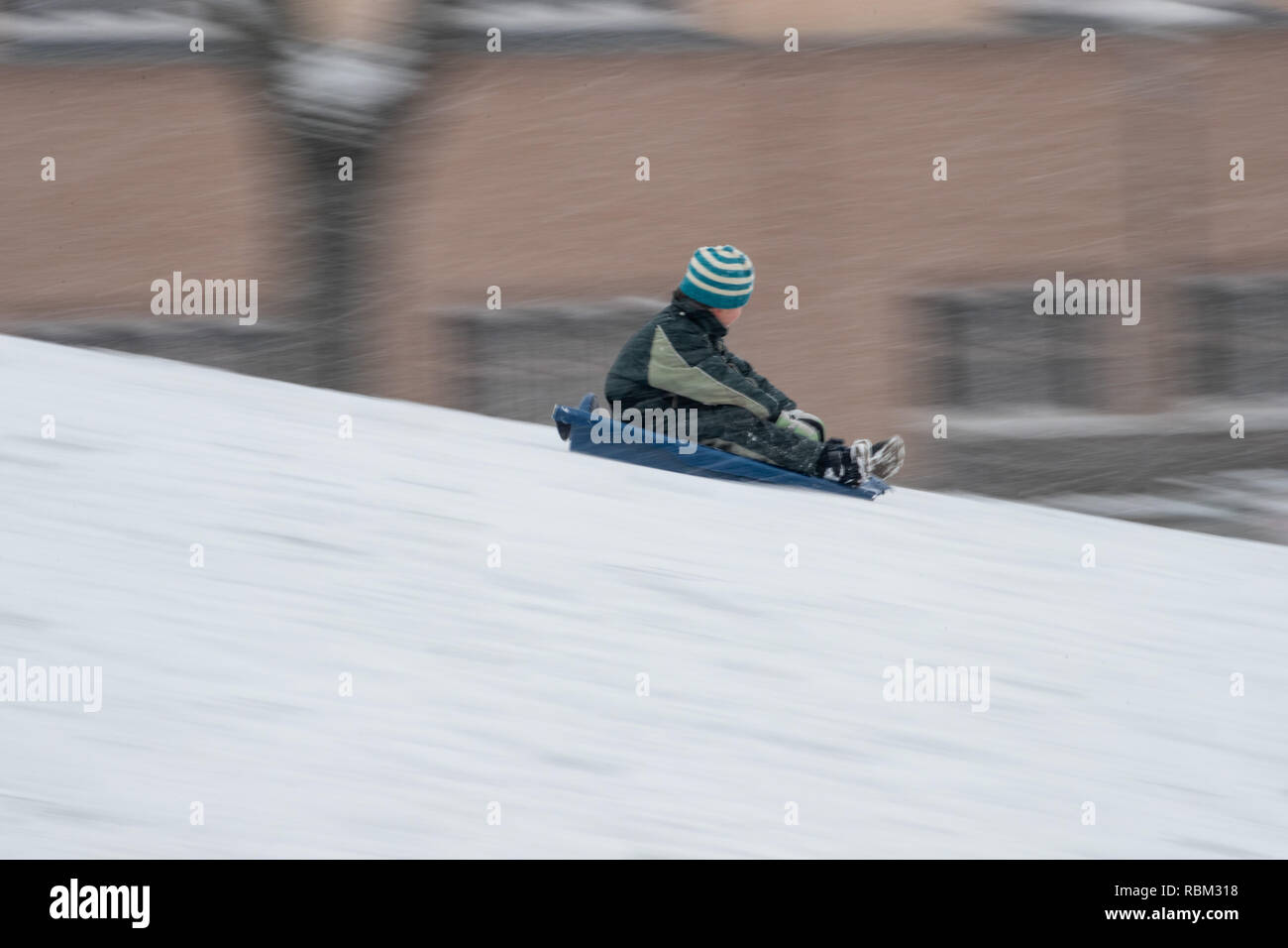 Nuremberg, Germany. 11th Jan 2019.A child slides down a snow-covered ...