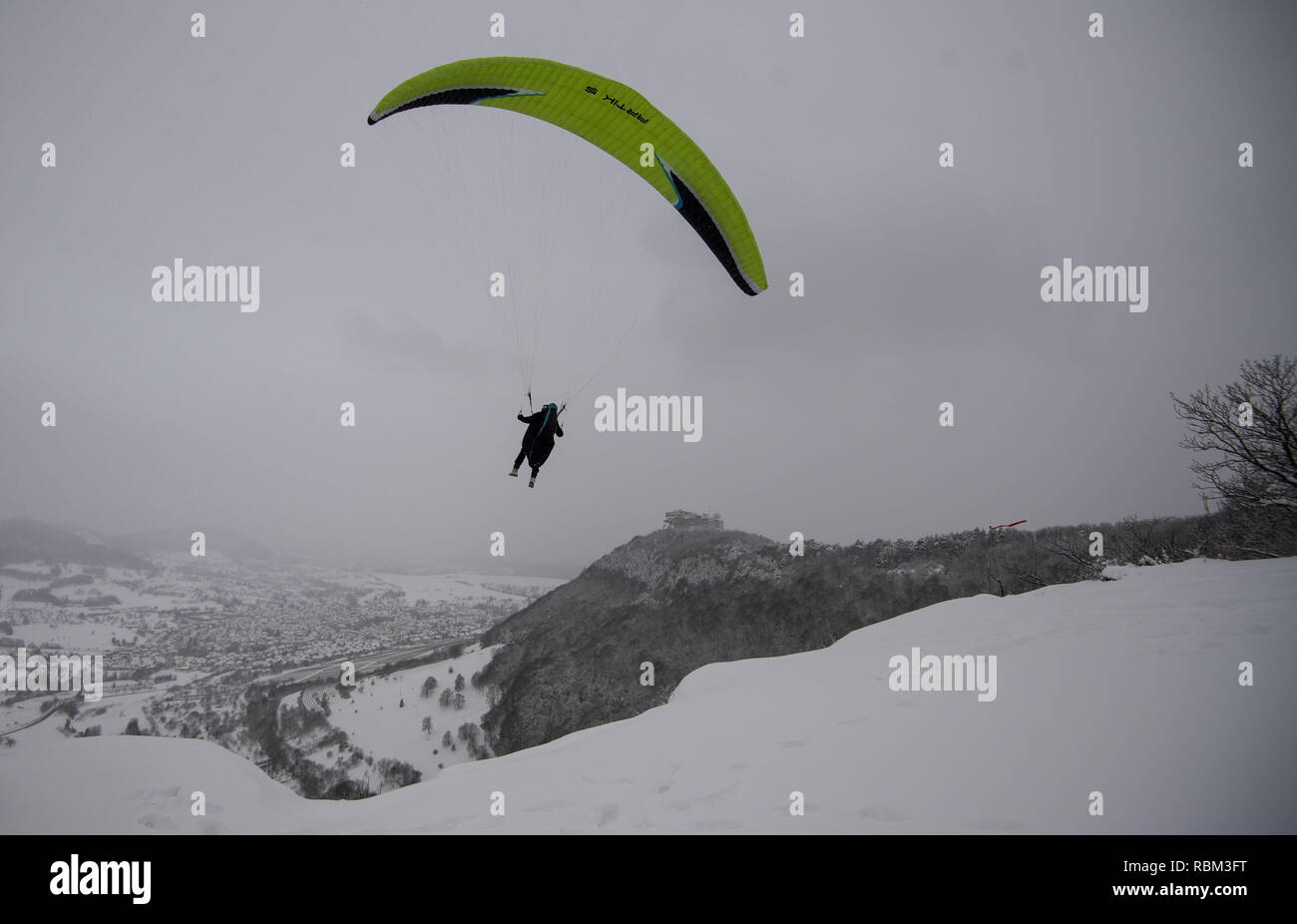 Neuffen, Germany. 11th Jan, 2019. A paraglider flies in front of ...