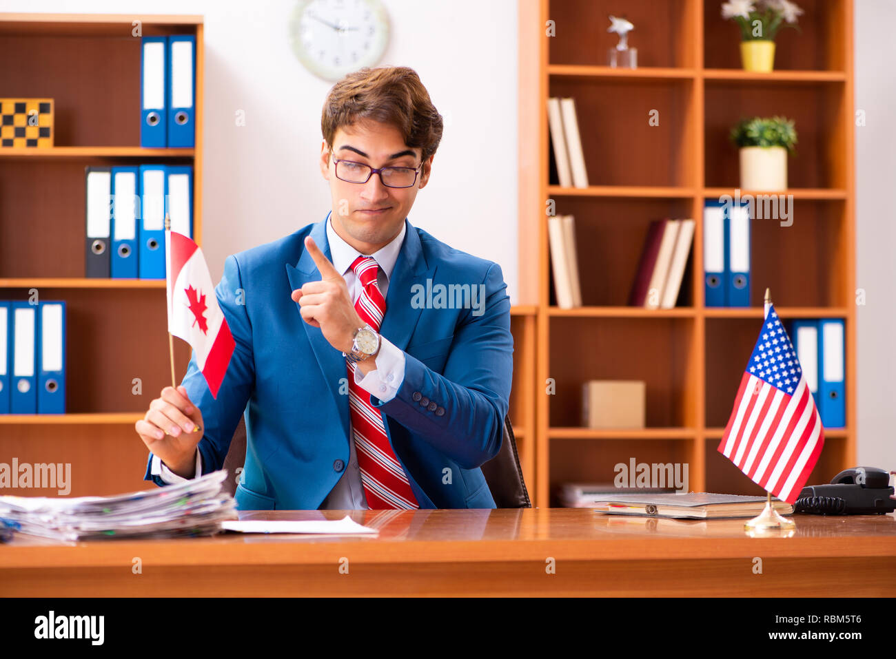 Young handsome politician sitting in office Stock Photo - Alamy