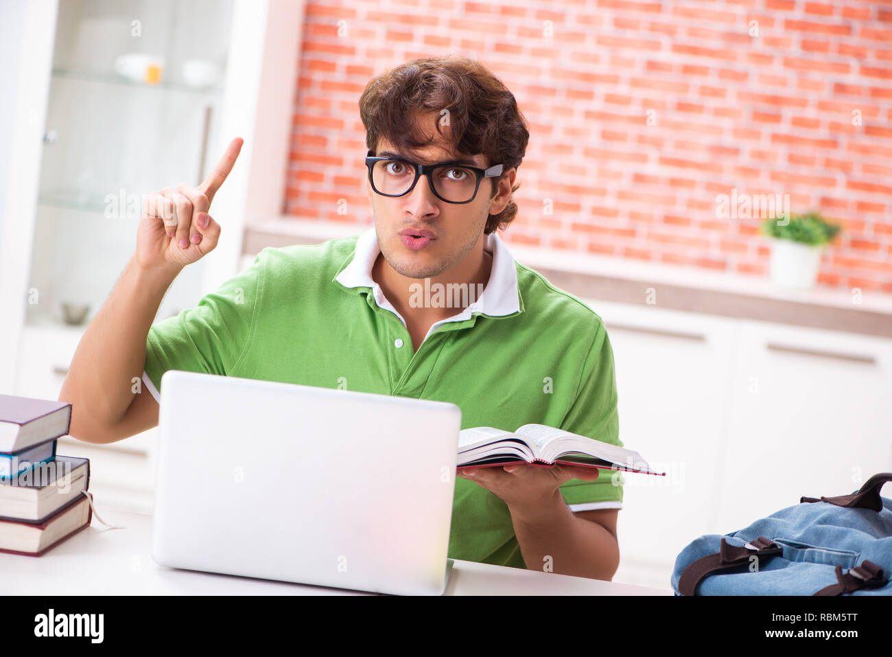 Teenager revising laptop books at home hi-res stock photography and ...