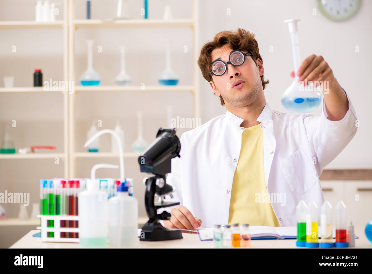Funny crazy chemist doing experiments and tests Stock Photo - Alamy