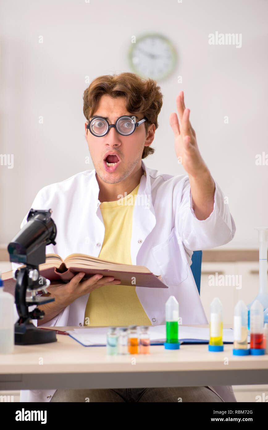 Funny crazy chemist doing experiments and tests Stock Photo - Alamy