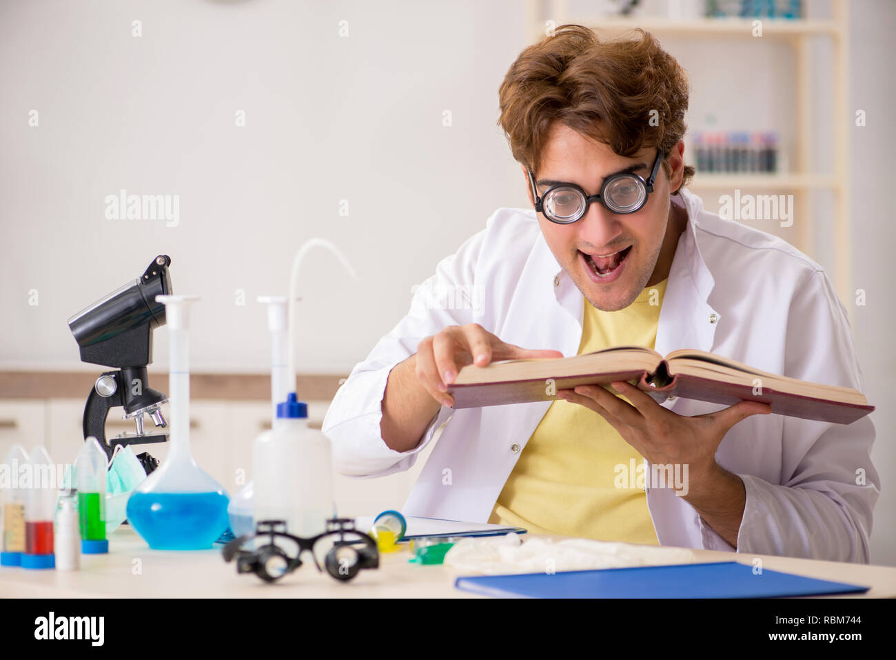 Funny crazy chemist doing experiments and tests Stock Photo - Alamy