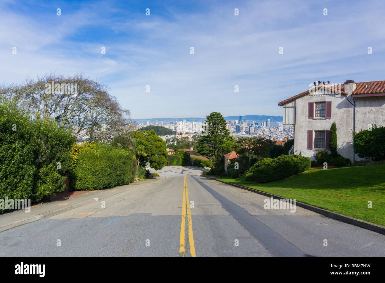 Two way street in the residential area of San Francisco; downtown views ...