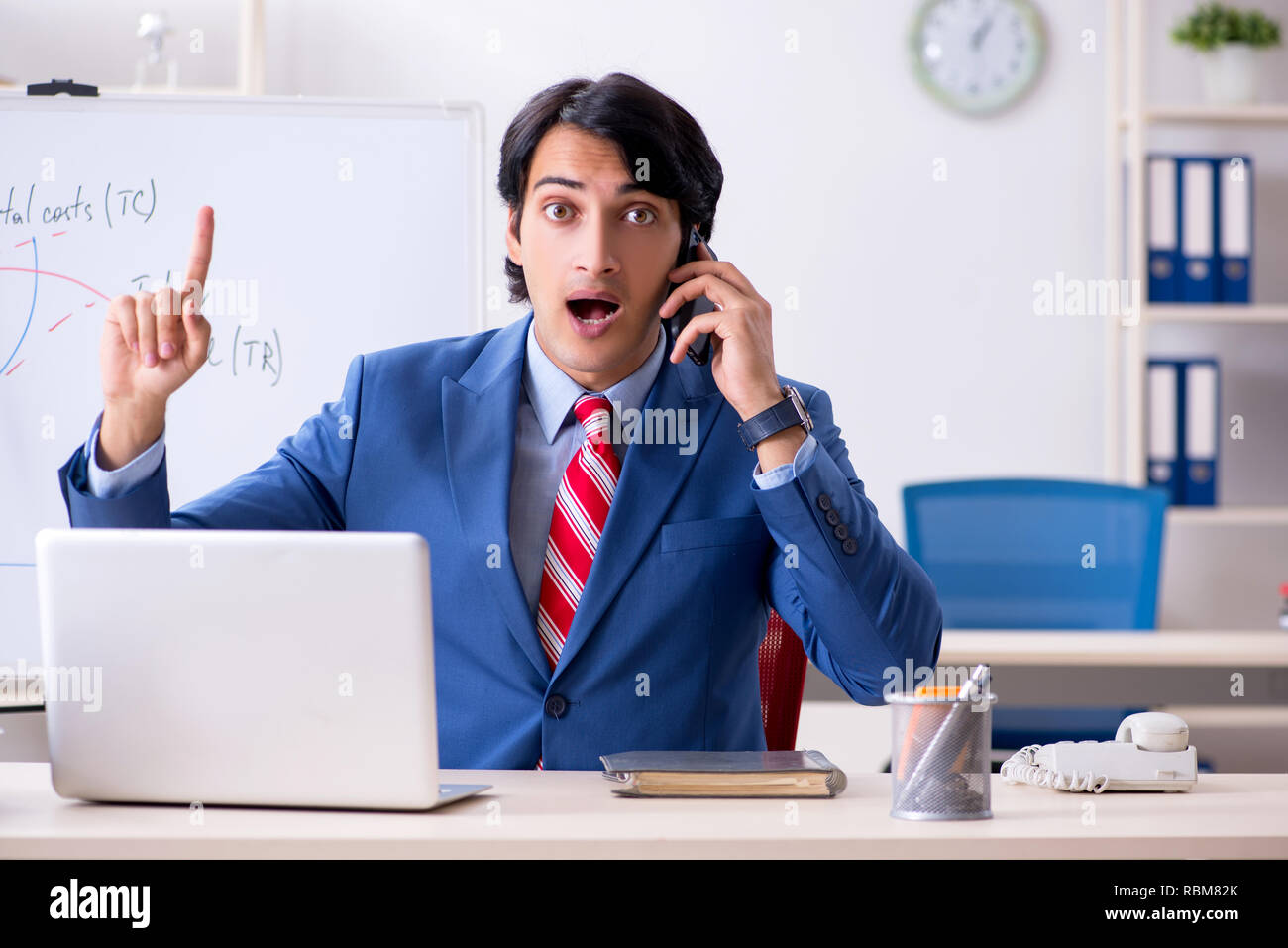 Busy businessman explaining business charts Stock Photo - Alamy