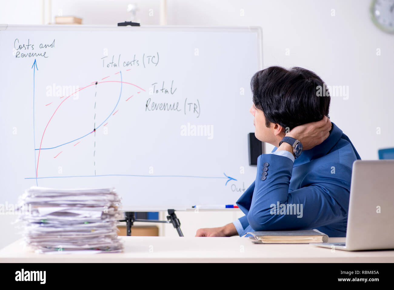 Busy businessman explaining business charts Stock Photo - Alamy