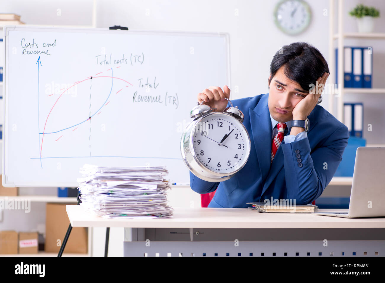 Busy businessman explaining business charts Stock Photo - Alamy