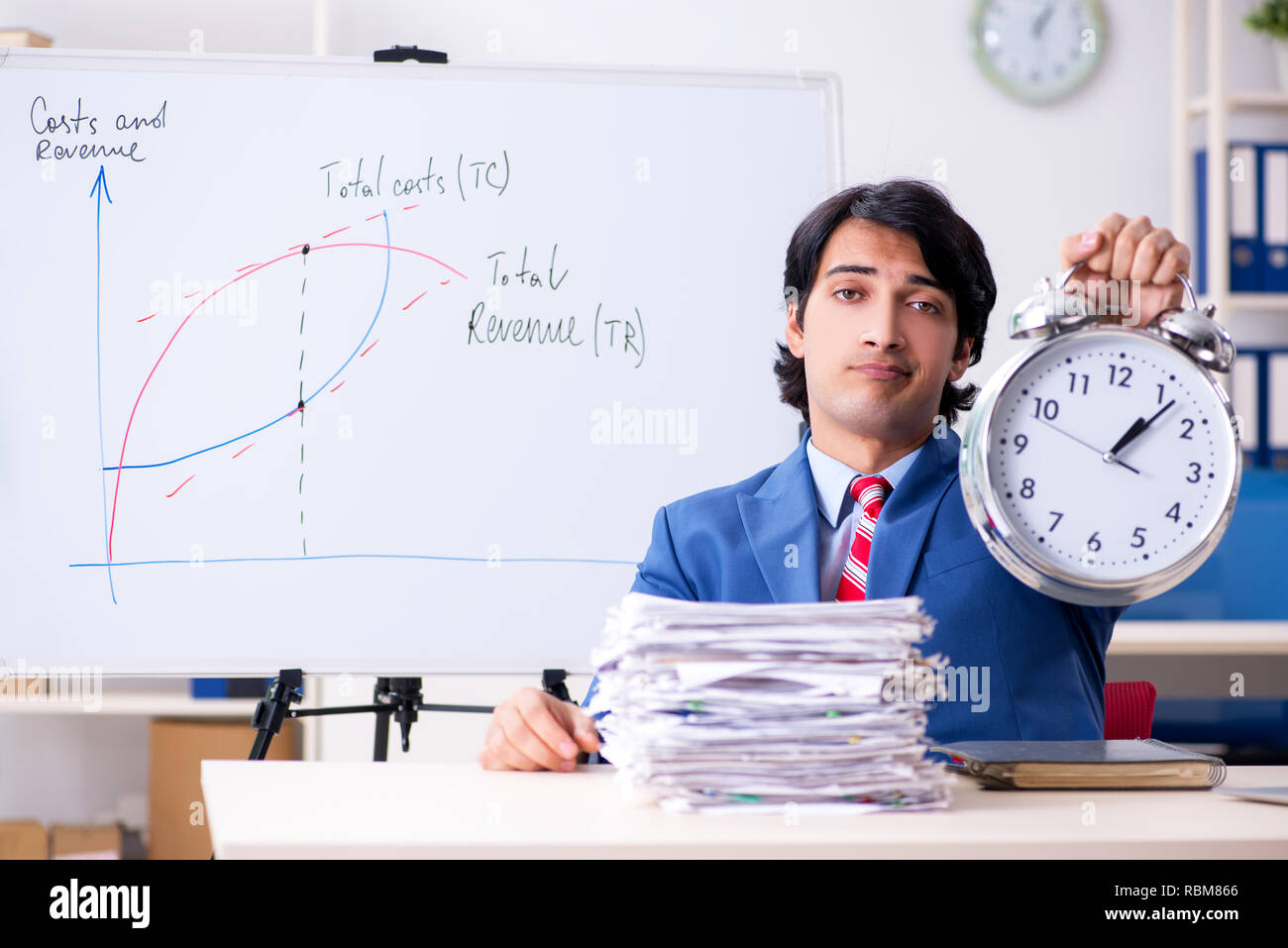 Busy businessman explaining business charts Stock Photo - Alamy