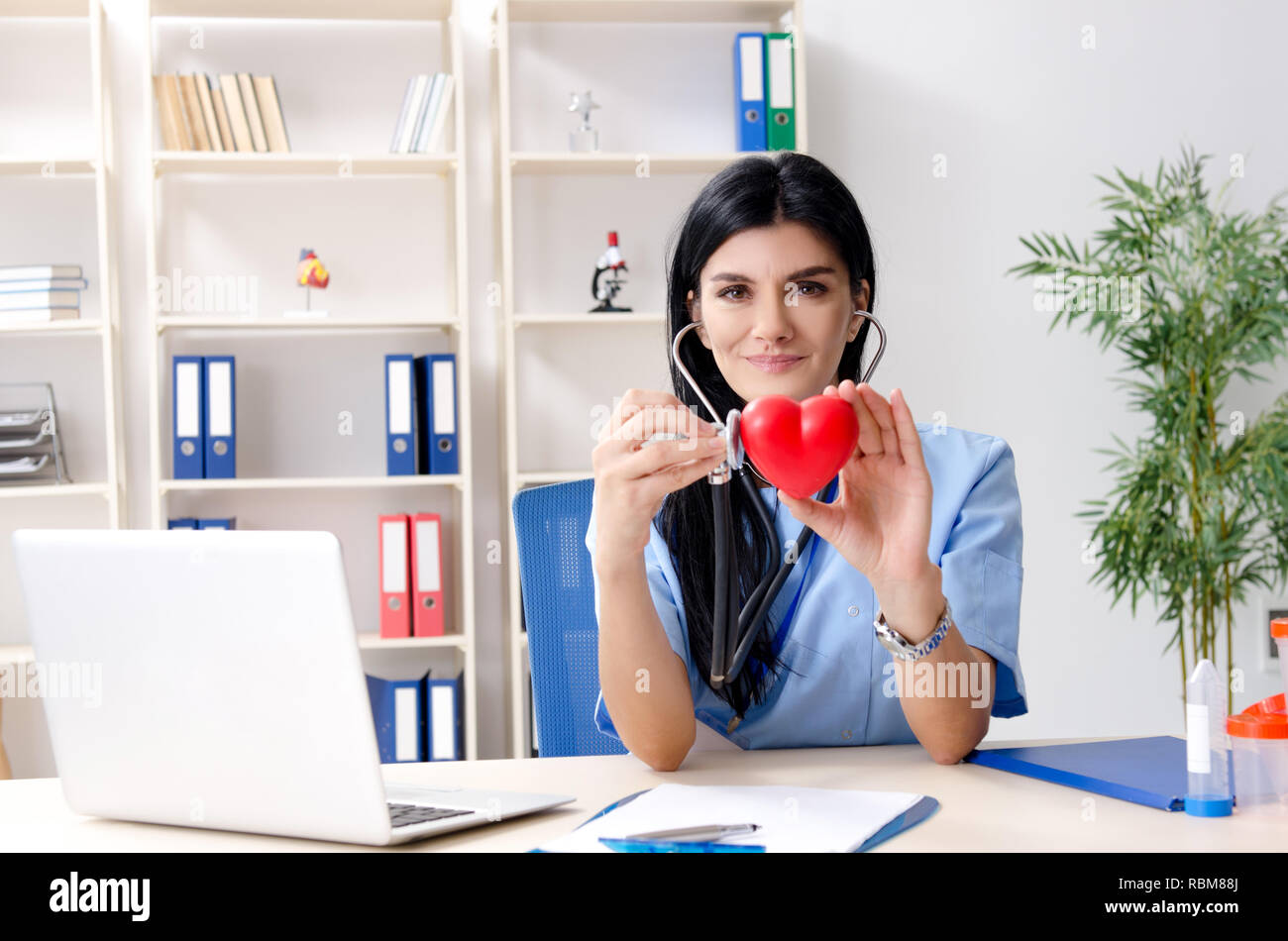 Female doctor cardiologist working in the clinic Stock Photo - Alamy