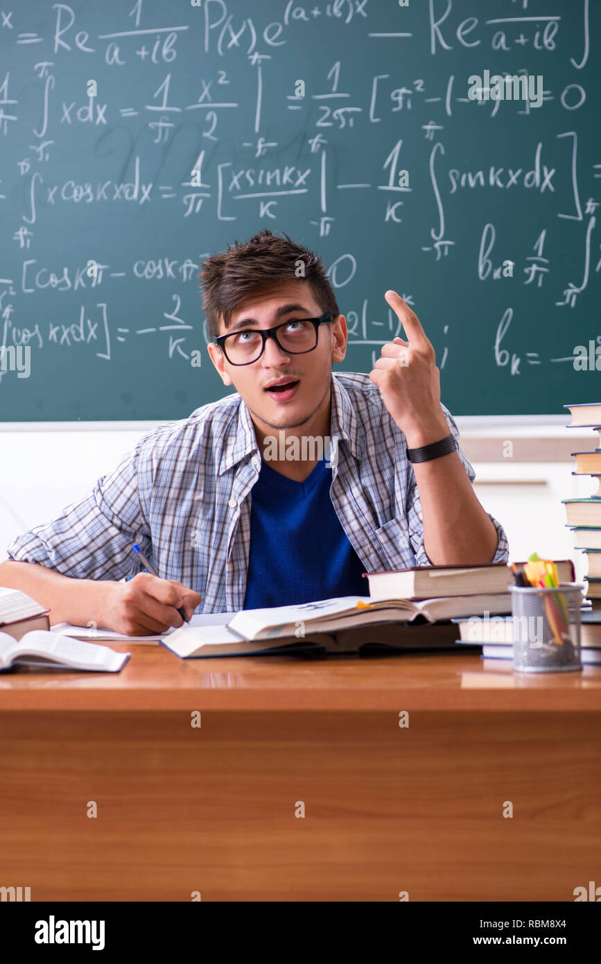 Young male student studying math at school Stock Photo - Alamy