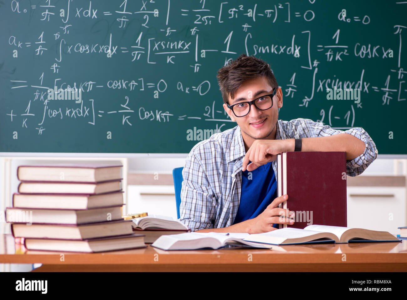 Young male student studying math at school Stock Photo - Alamy