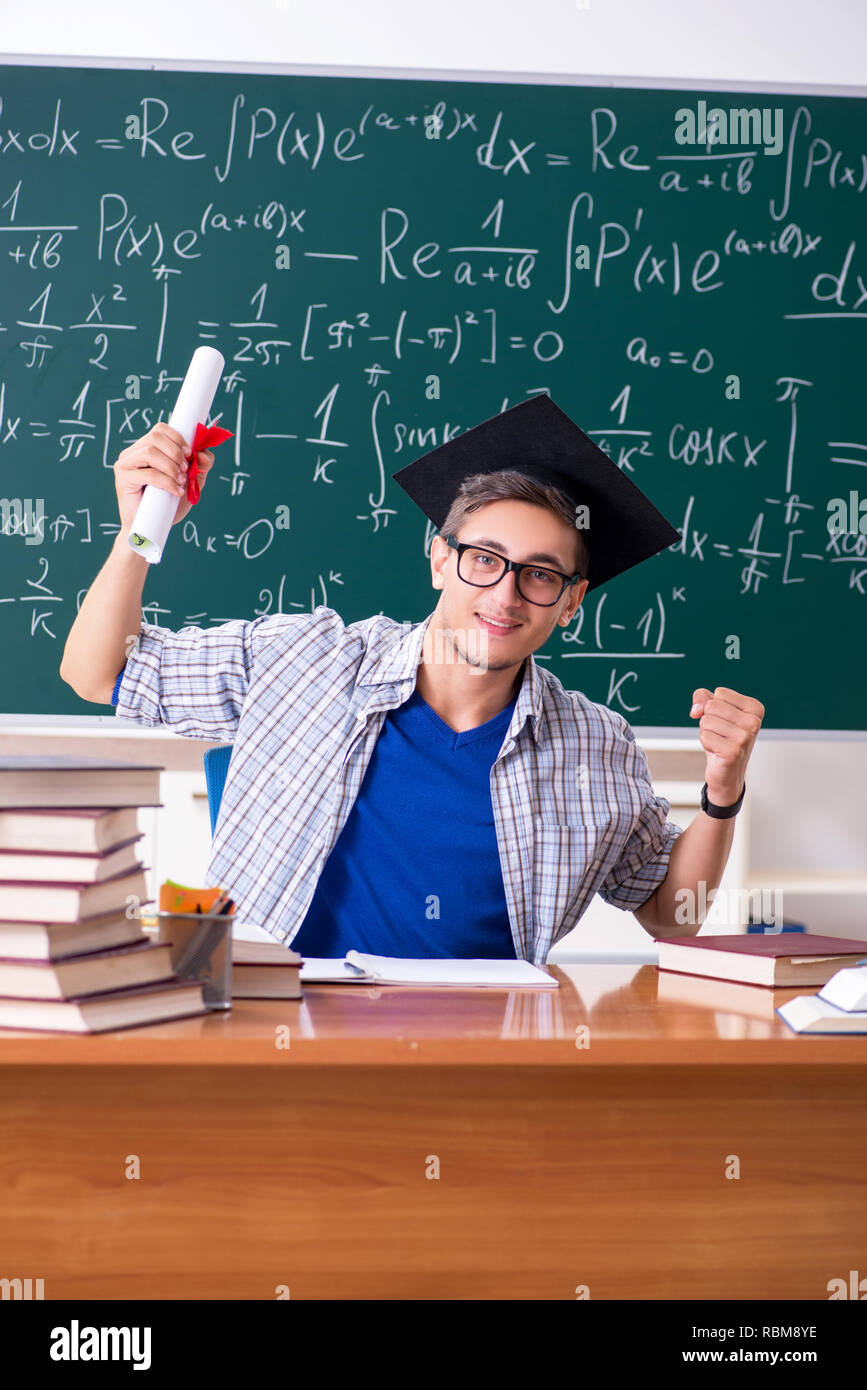 Young male student studying math at school Stock Photo - Alamy