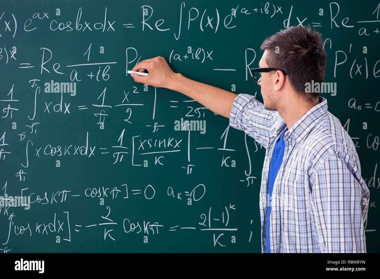 Young male student studying math at school Stock Photo - Alamy