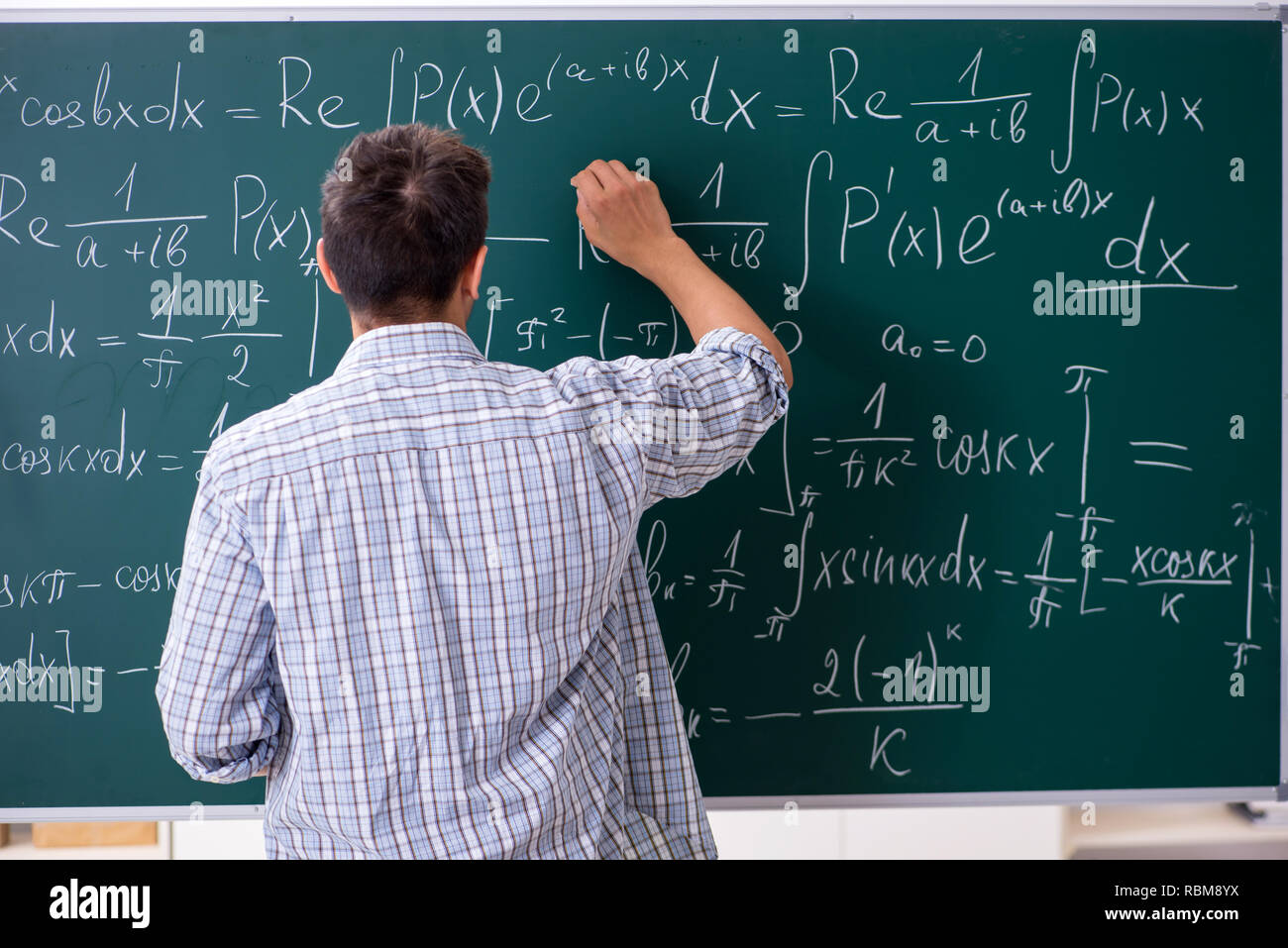 Young male student studying math at school Stock Photo - Alamy