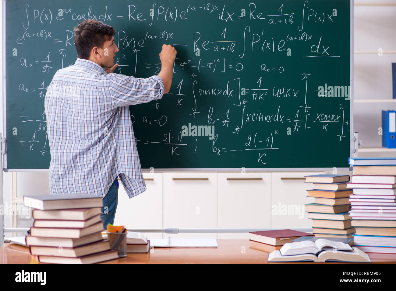 Young male student studying math at school Stock Photo - Alamy