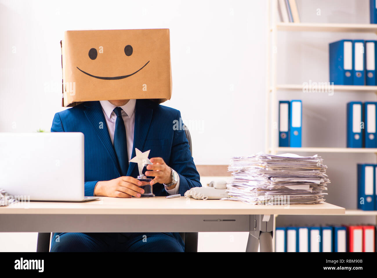 Happy man employee with box instead of his head Stock Photo - Alamy
