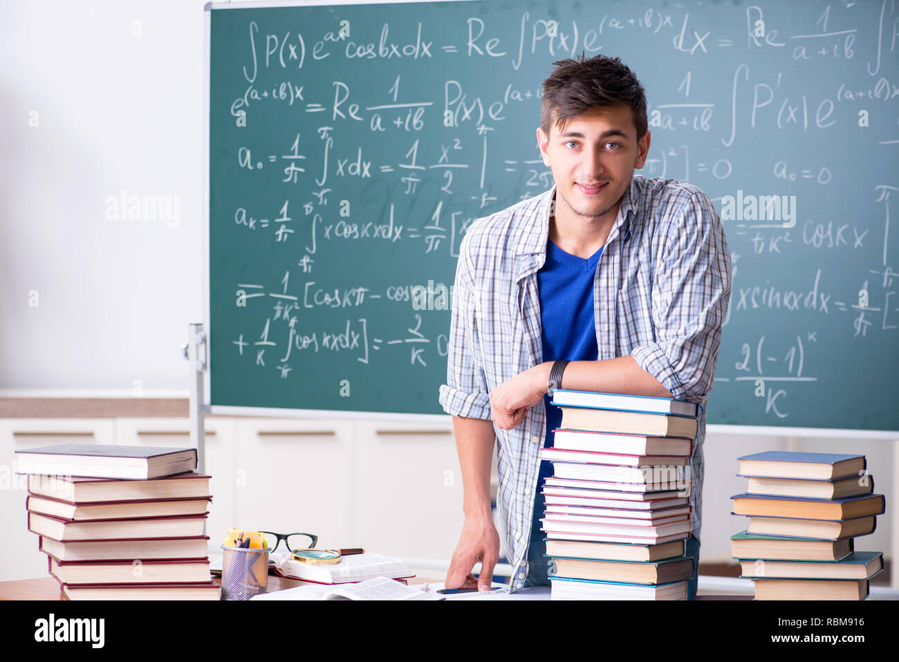 Young male student studying math at school Stock Photo - Alamy
