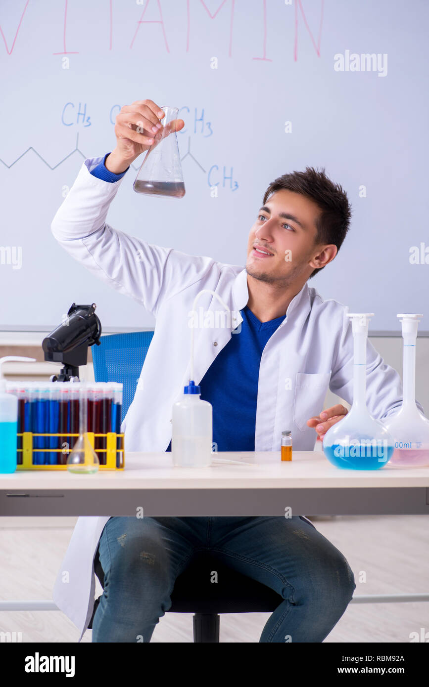 Happy young chemist mixing hi-res stock photography and images - Alamy