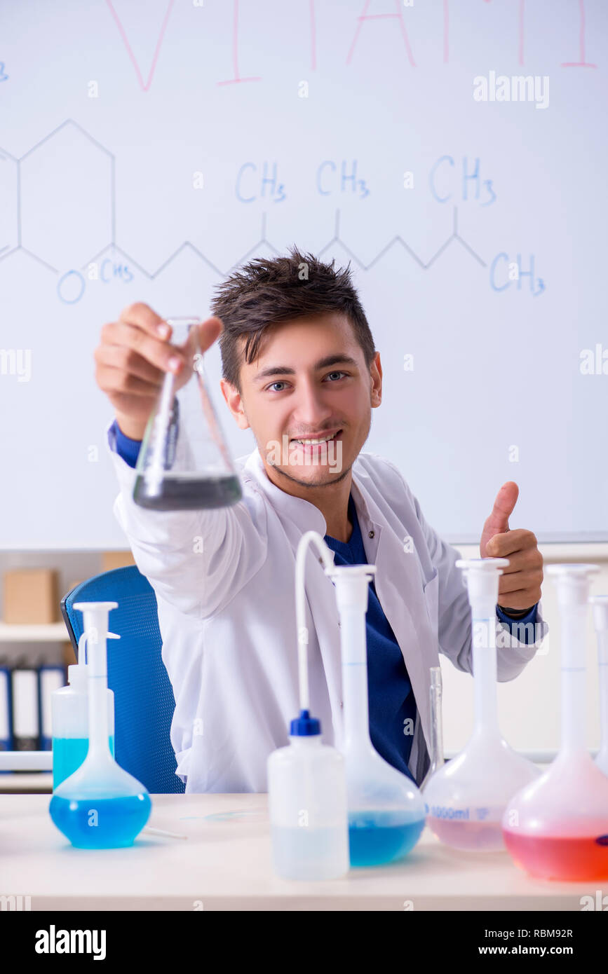 Happy young chemist mixing hi-res stock photography and images - Alamy
