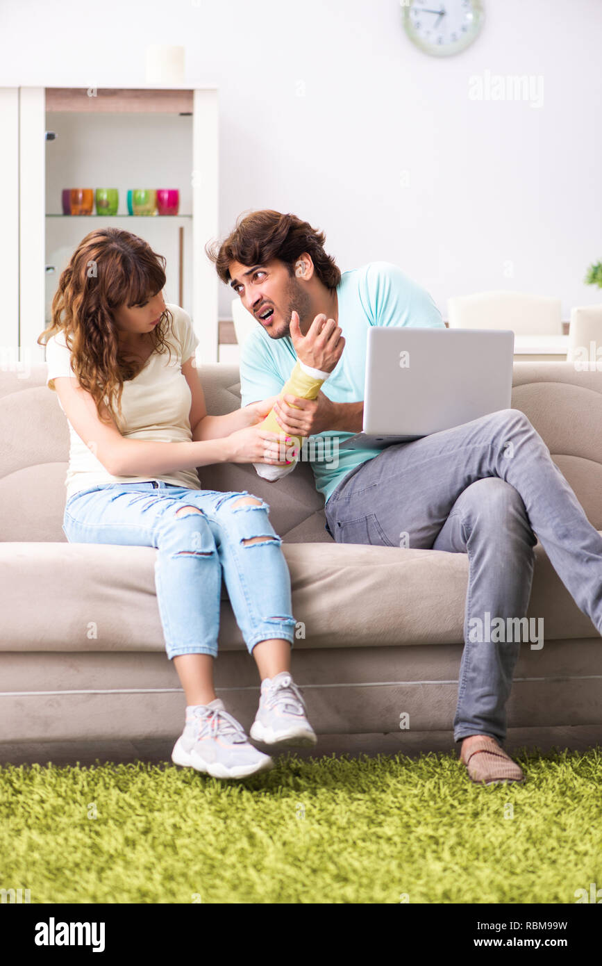 Young family helping each other after injury Stock Photo - Alamy
