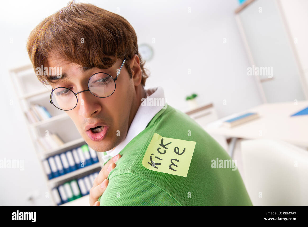 Office prank with kick me message on sticky note Stock Photo - Alamy