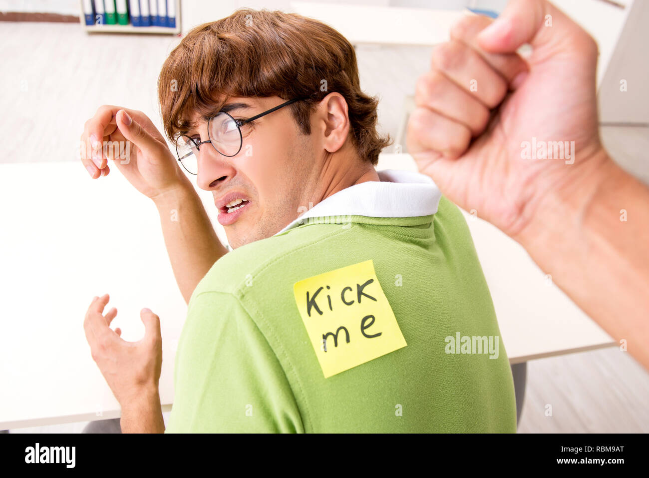 Office prank with kick me message on sticky note Stock Photo - Alamy