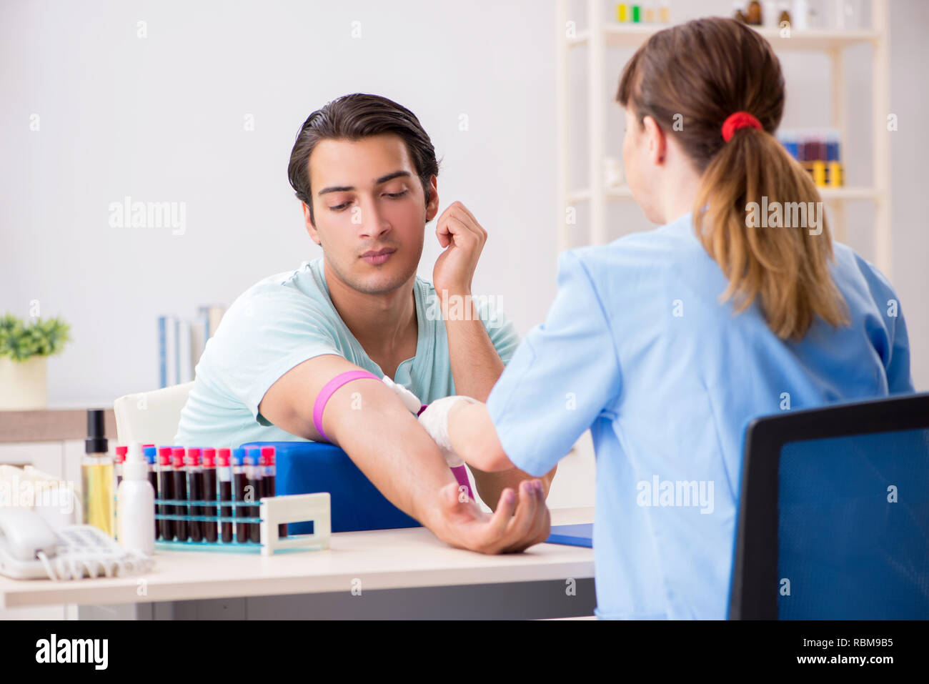 Young patient during blood test sampling procedure Stock Photo - Alamy