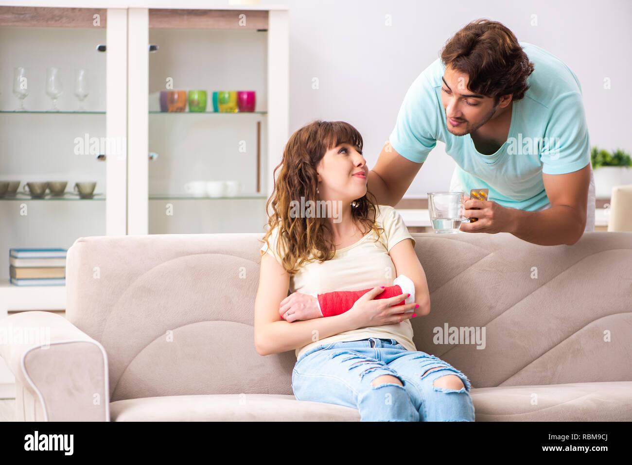 Young family helping each other after injury Stock Photo - Alamy
