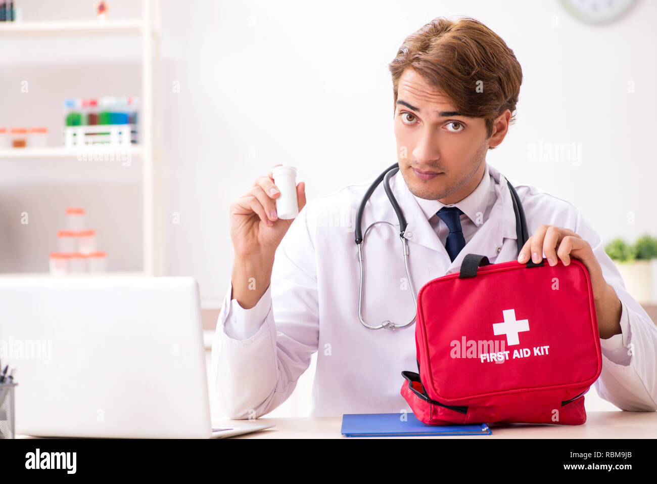 Young doctor with first aid kit in hospital Stock Photo - Alamy