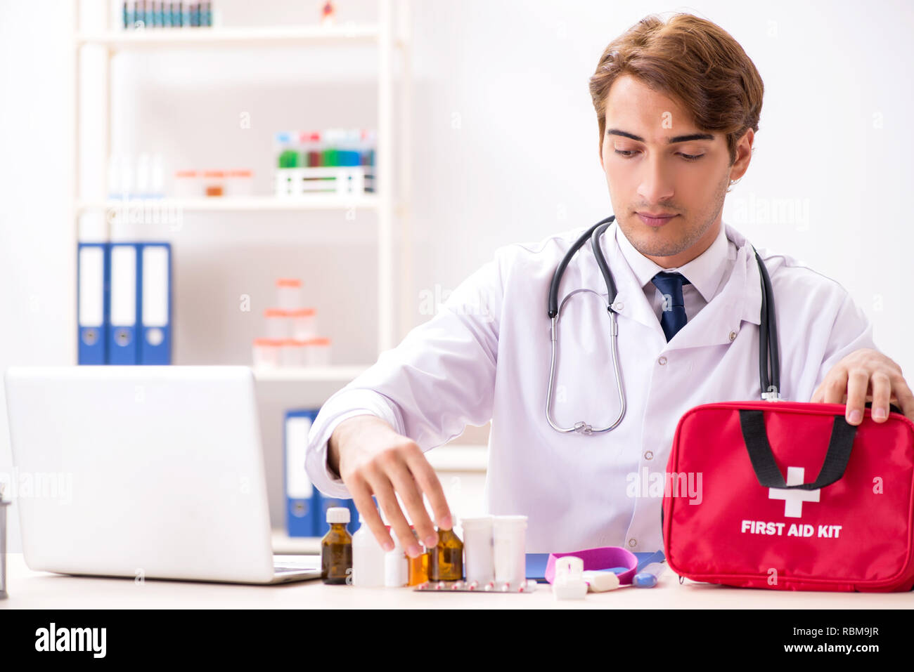 Young doctor with first aid kit in hospital Stock Photo - Alamy