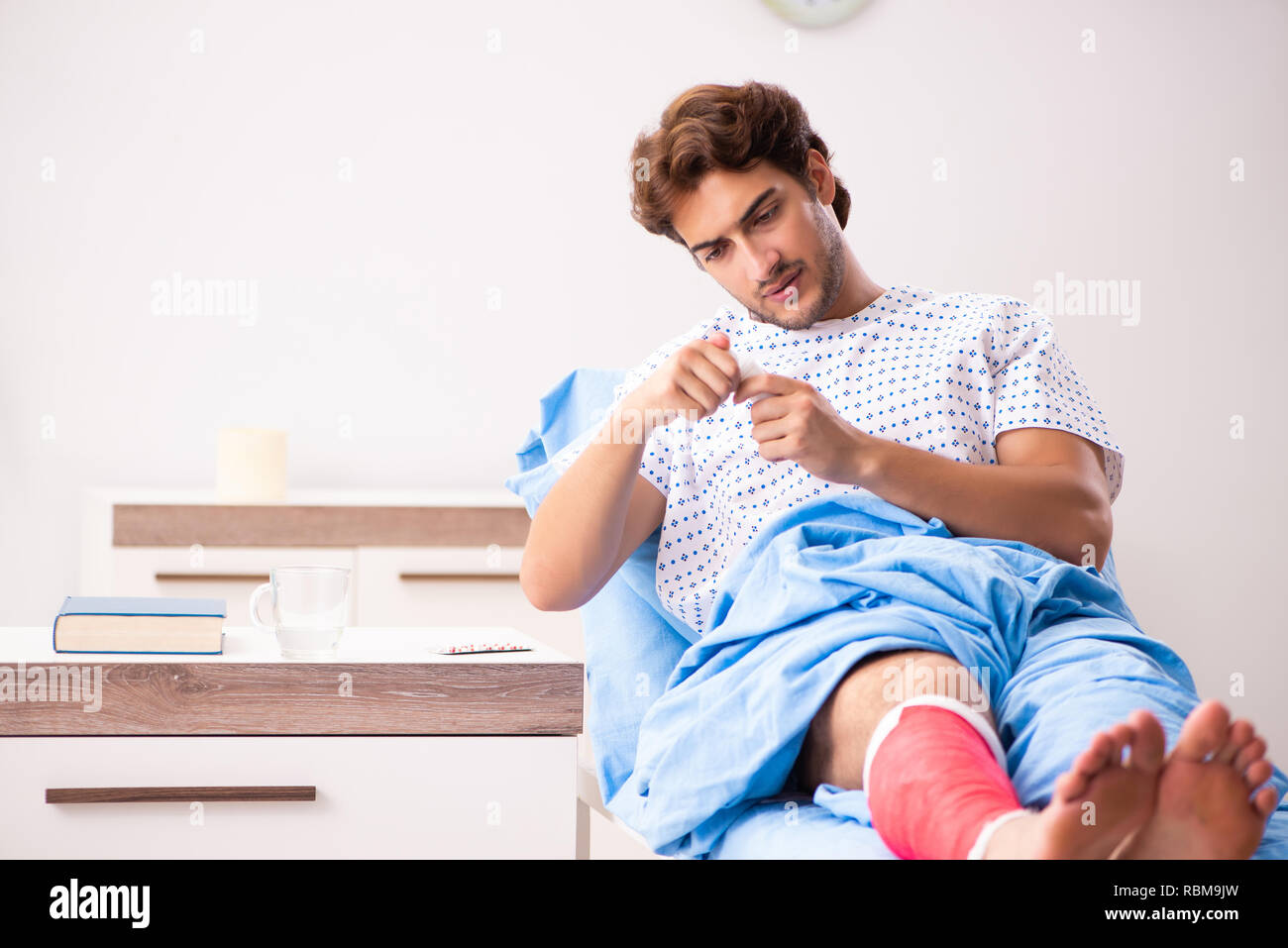 Injured man waiting treatment in the hospital Stock Photo - Alamy