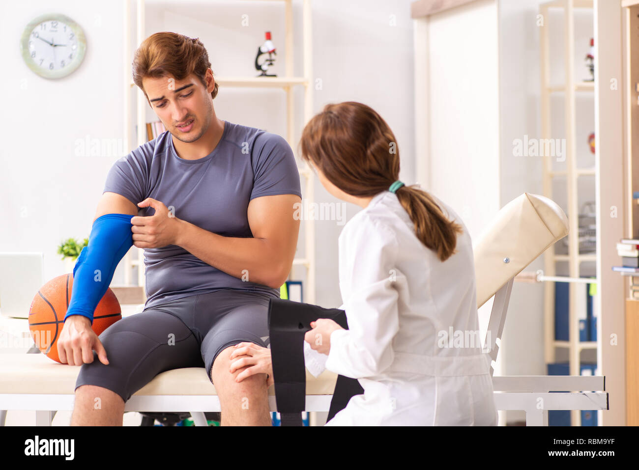Handsome basketball player visiting female doctor traumatologist Stock ...