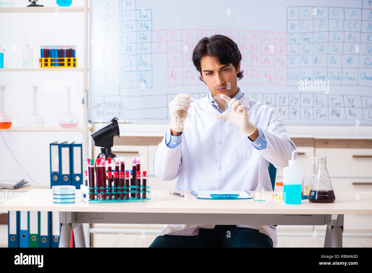 Young chemist working in the lab Stock Photo - Alamy