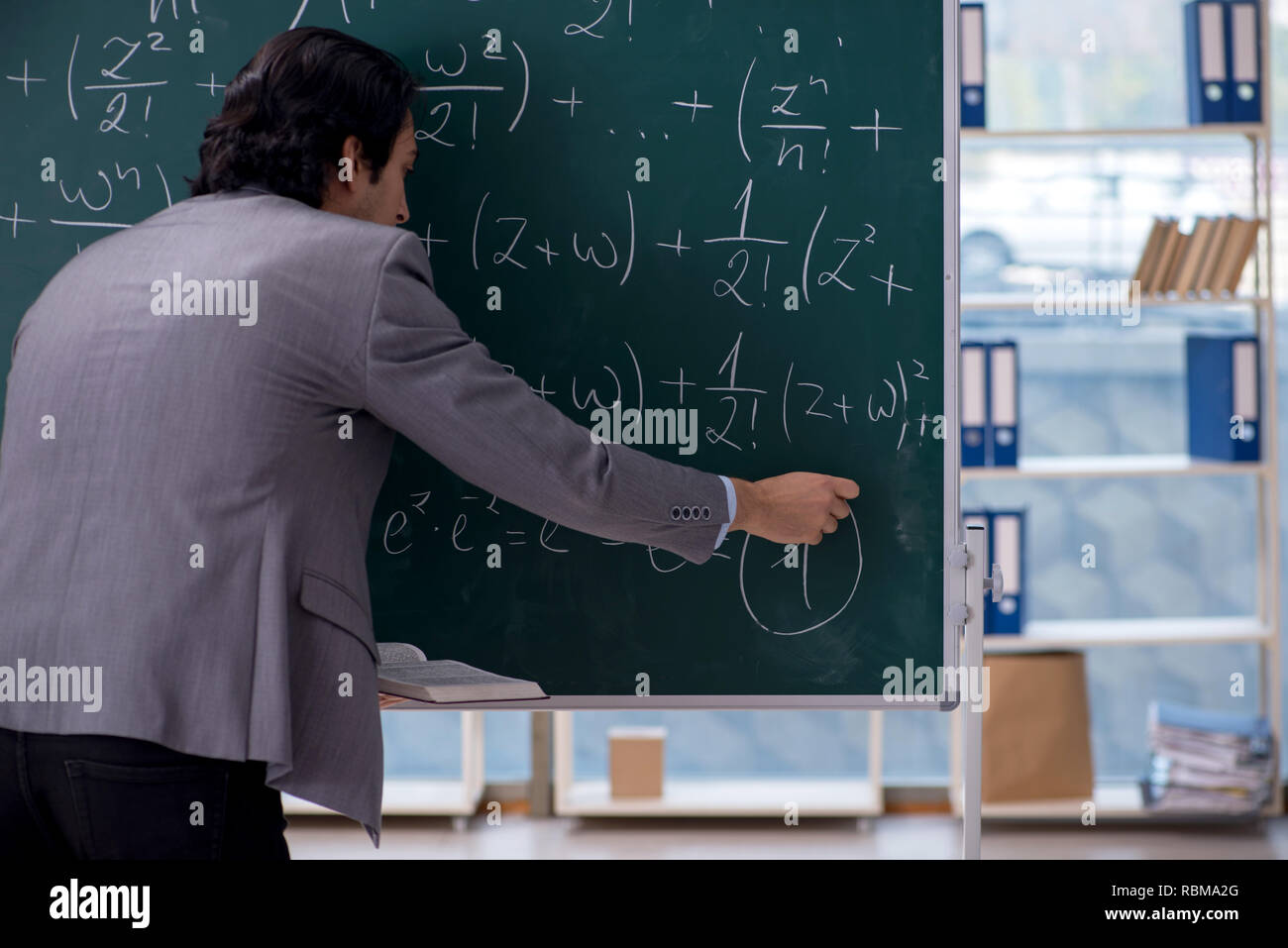 Back view young maths teacher hi-res stock photography and images - Alamy