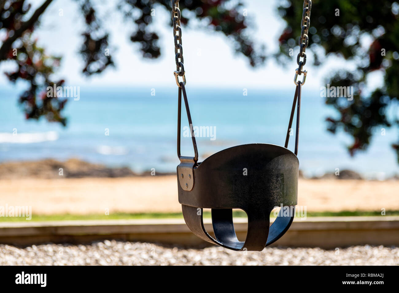 An empty swing by the sea Stock Photo - Alamy