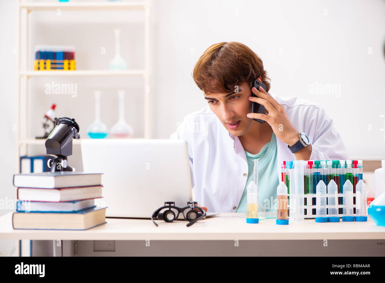 Young chemist working in the lab Stock Photo - Alamy