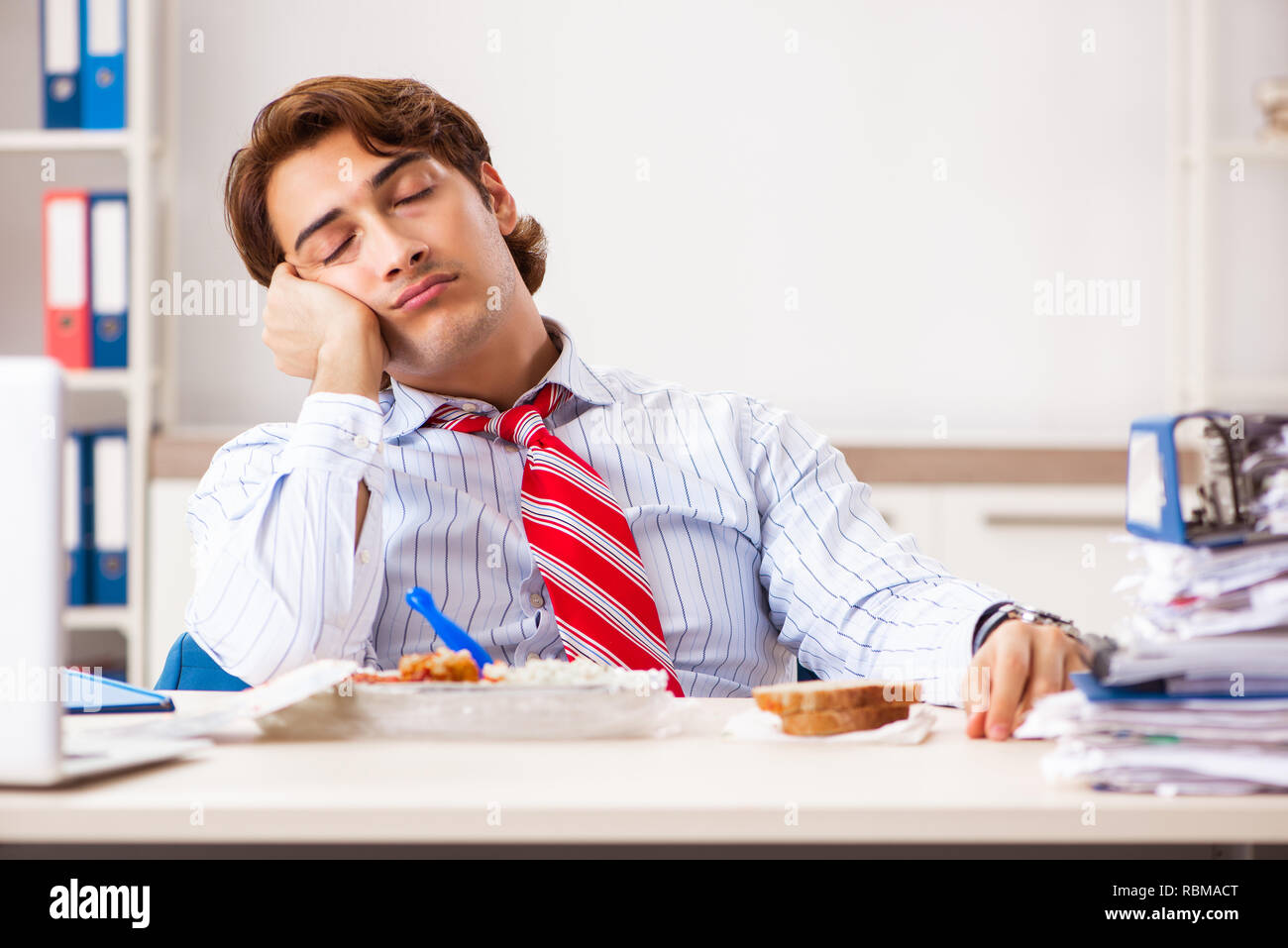 Man having meal at work during break Stock Photo - Alamy