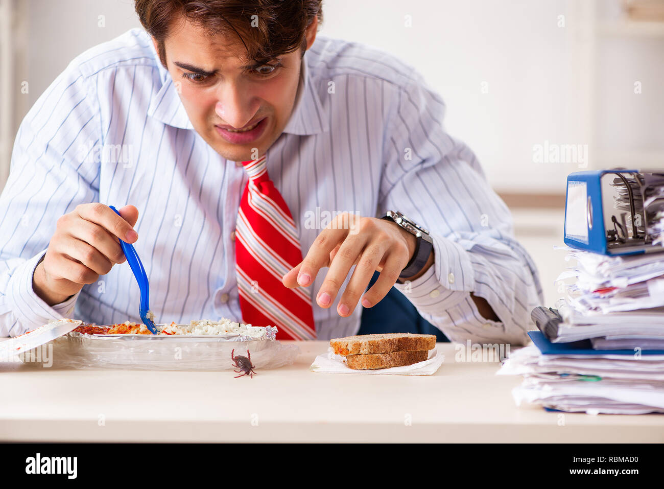Employee eating food with cockroaches crawling around Stock Photo - Alamy