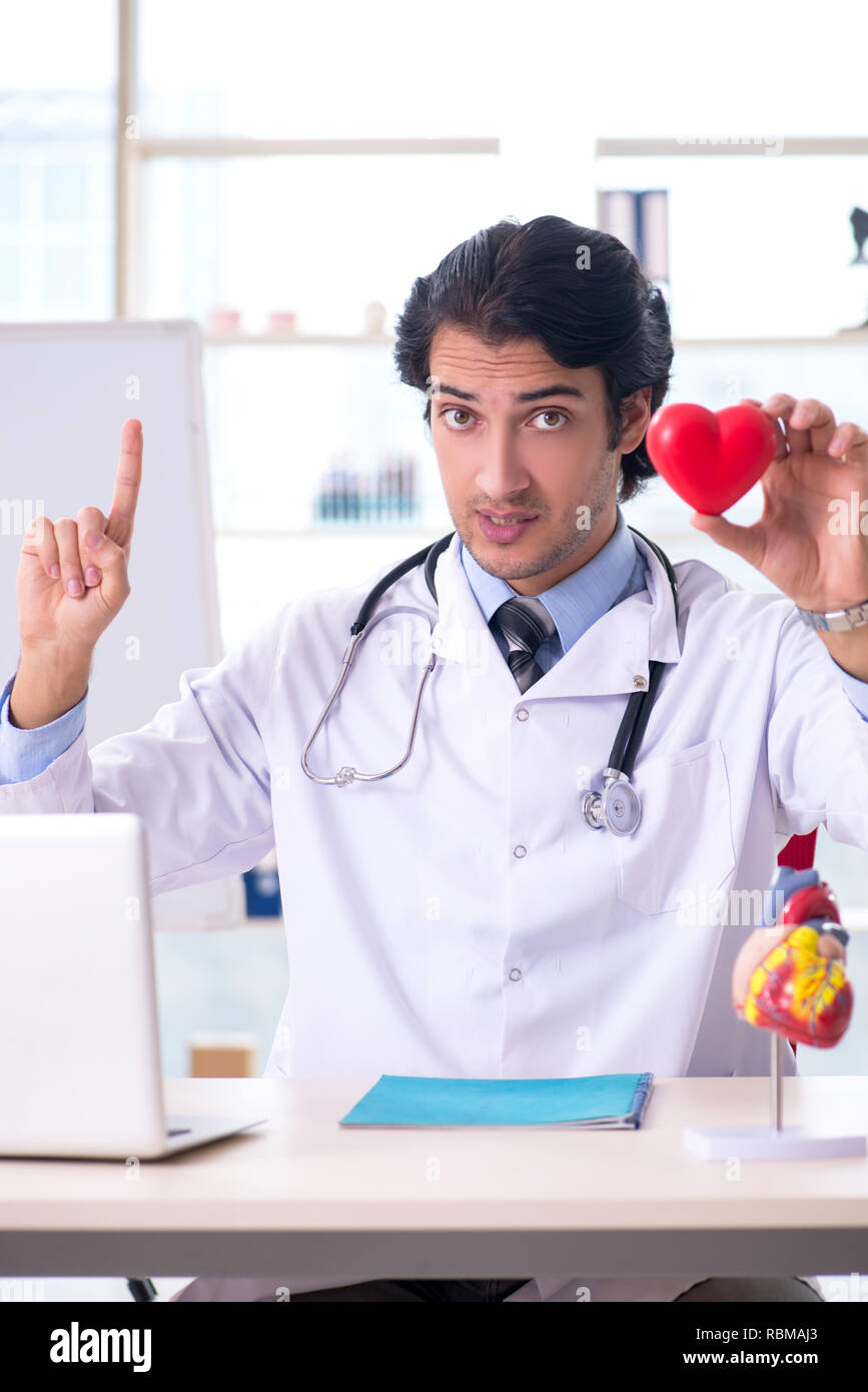 Young handsome doctor cardiologist in front of whiteboard Stock Photo ...